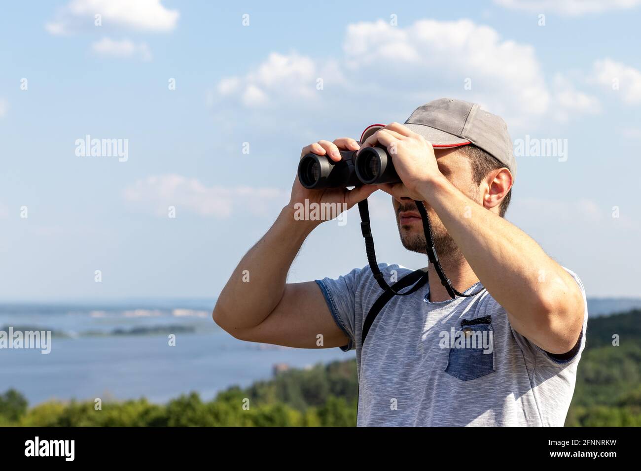 Man with binoculars tree hi-res stock photography and images - Alamy