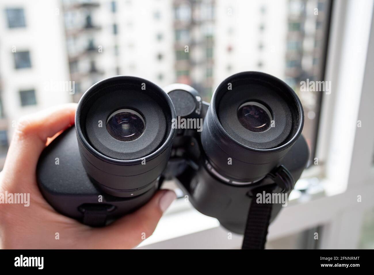Woman spying window hi-res stock photography and images - Alamy