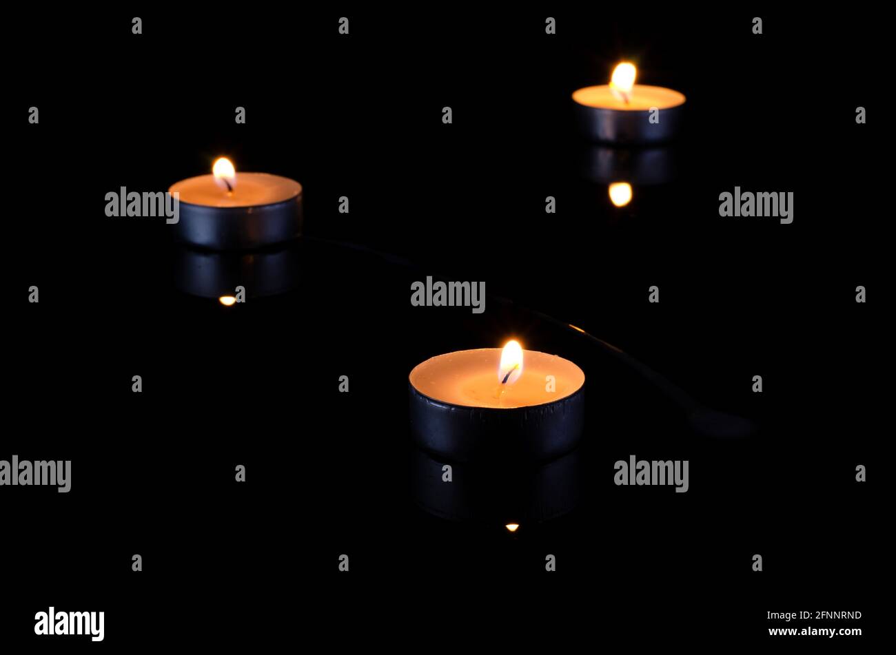 Burning candle in a black background with reflection Stock Photo - Alamy