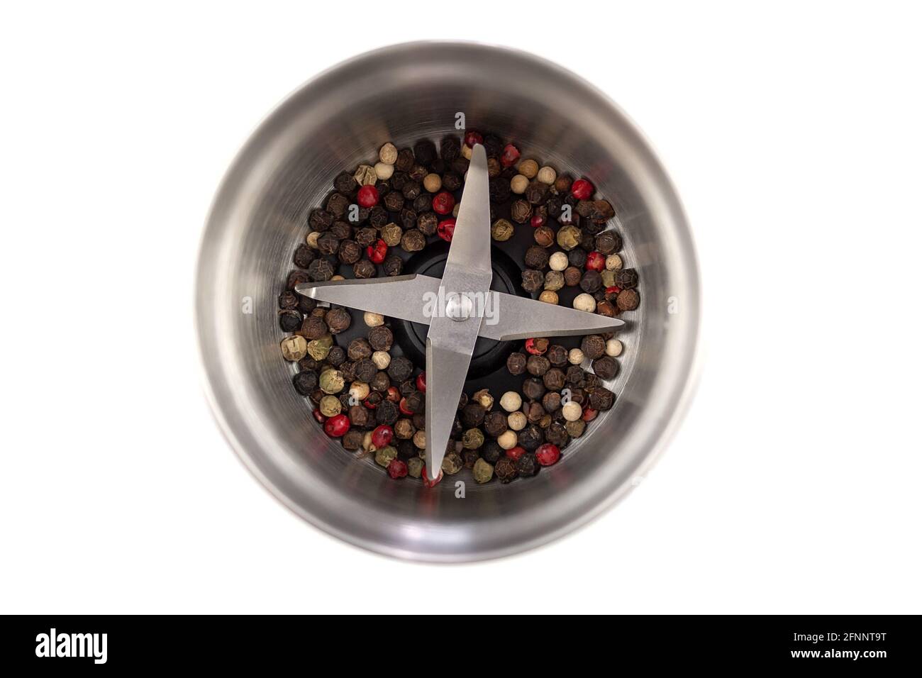 Modern steel pepper grinder with a small amount of pepper mix isolated ...