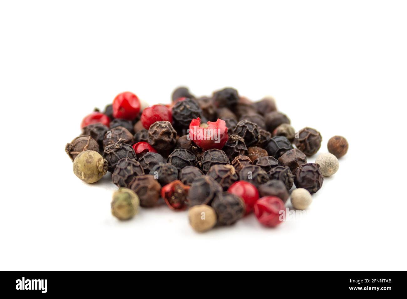 A mix of four types of pepper grain: black, white, pink, green ...
