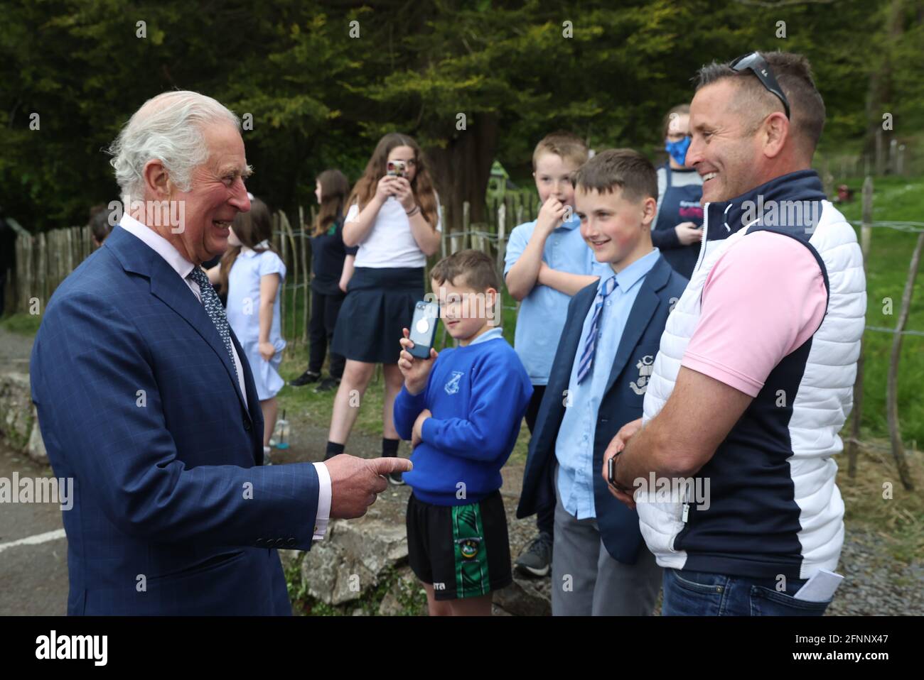 The Prince of Wales greets people in the car park during a visit to ...