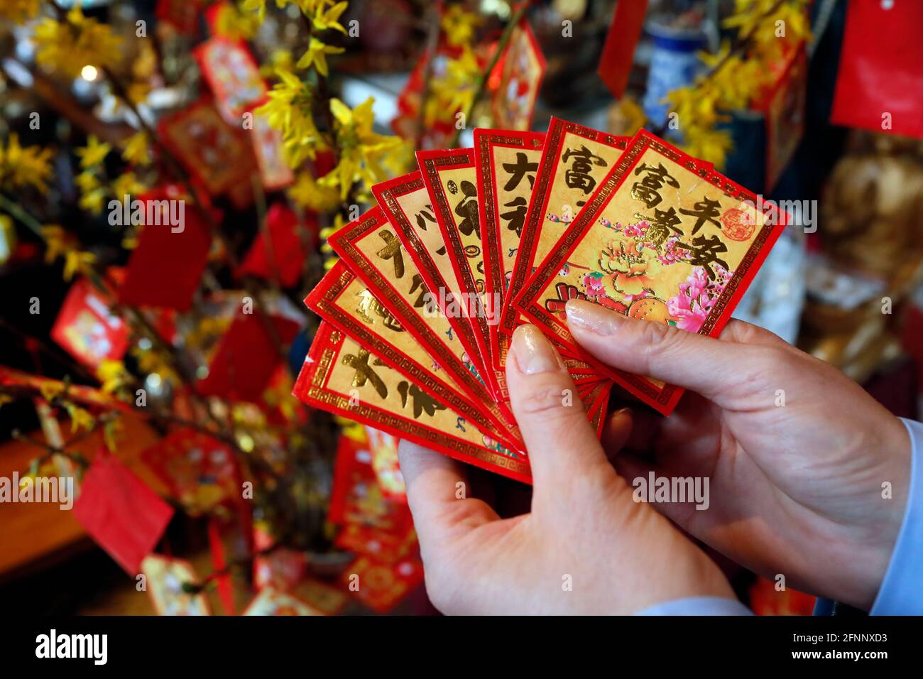 Tu An pagoda. Buddhist woman with red envelopes ( hongbao ) on yellow ...