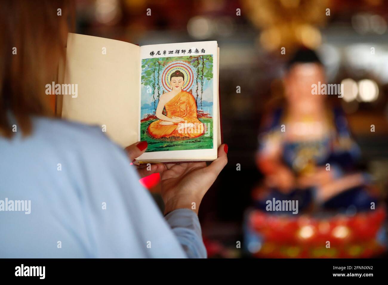 Thien Minh buddhist temple. Woman reading sacred buddhist texts ...