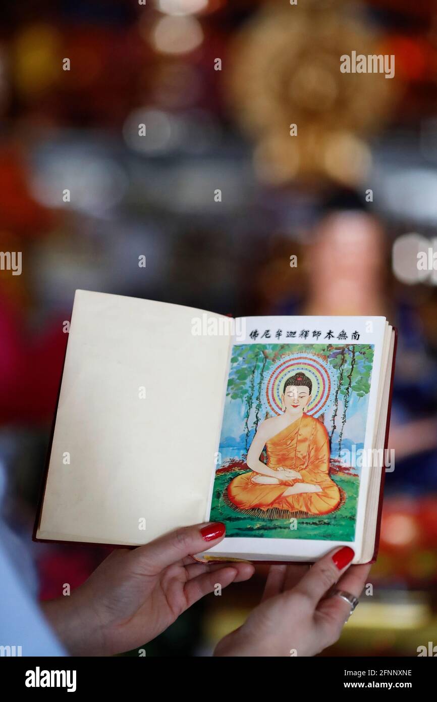 Thien Minh buddhist temple. Woman reading sacred buddhist texts ...