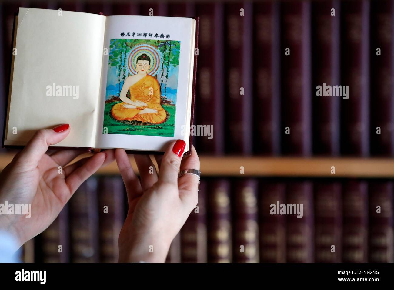 Thien Minh buddhist temple. Woman reading sacred buddhist texts ...