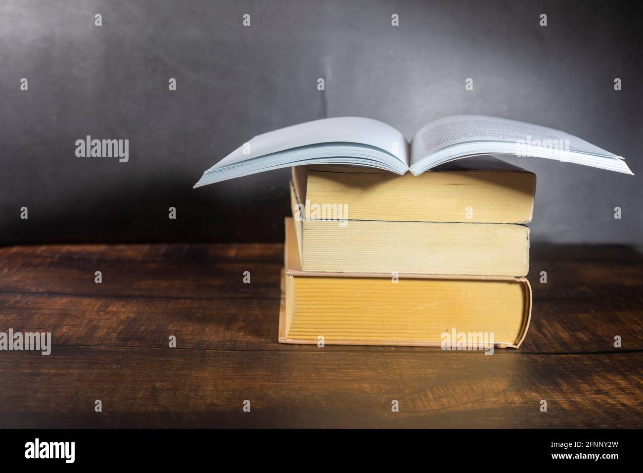 The Open Book On A Pile Books Stock Photo - Alamy