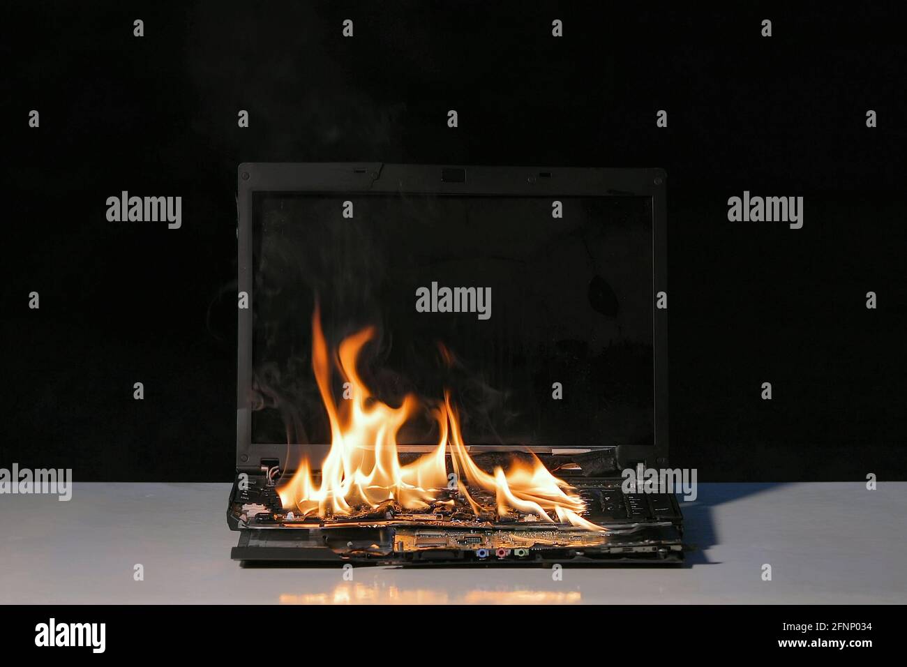 Burning laptop computer Stock Photo - Alamy