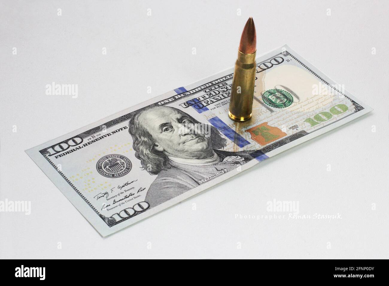 Bullet on dollar bill. Money on a white background. Bullet on a white ...