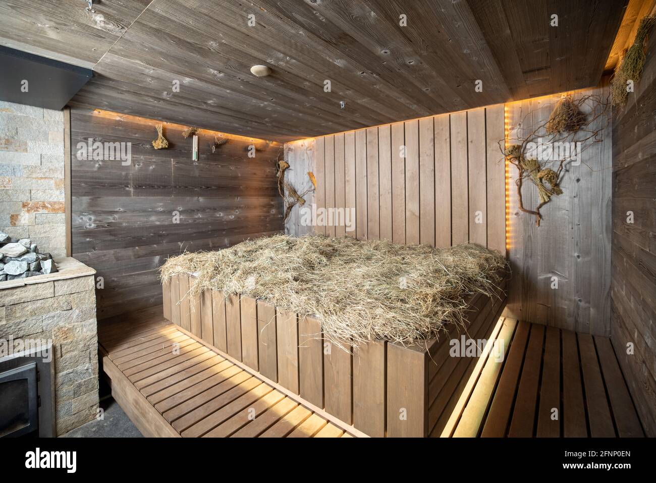 Interior of a wooden sauna, steam room, bathhouse with hay on wooden ...