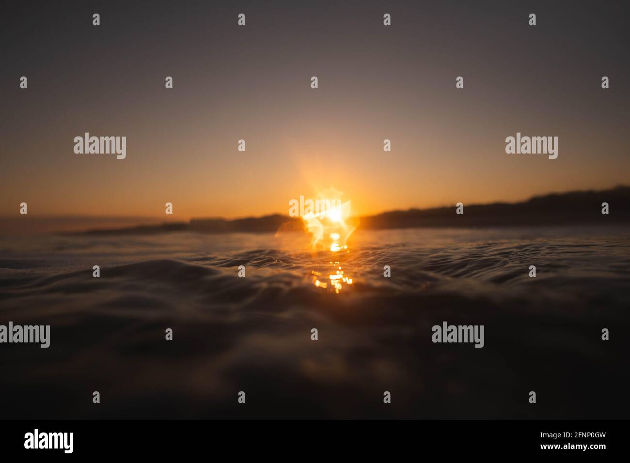 A sunrise seen over water Stock Photo - Alamy