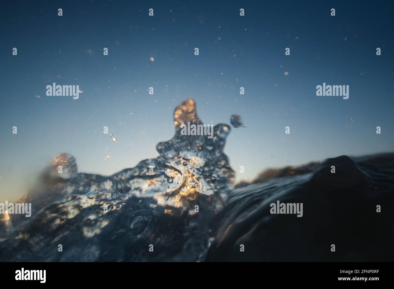 A drop of water splashes up in the sea Stock Photo - Alamy