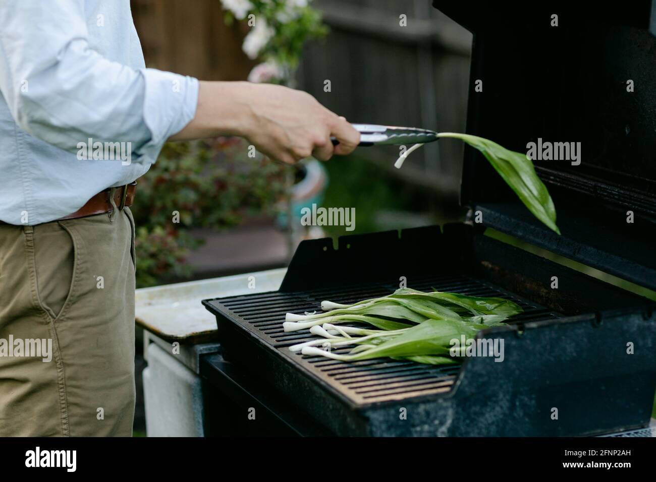 Putting on grill hi-res stock photography and images - Alamy