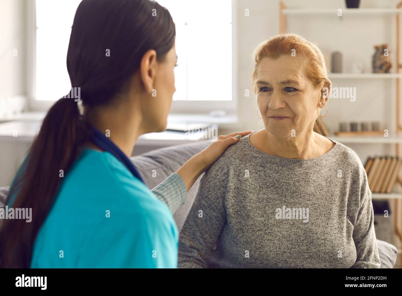 Female doctor helping old woman hi-res stock photography and images - Alamy