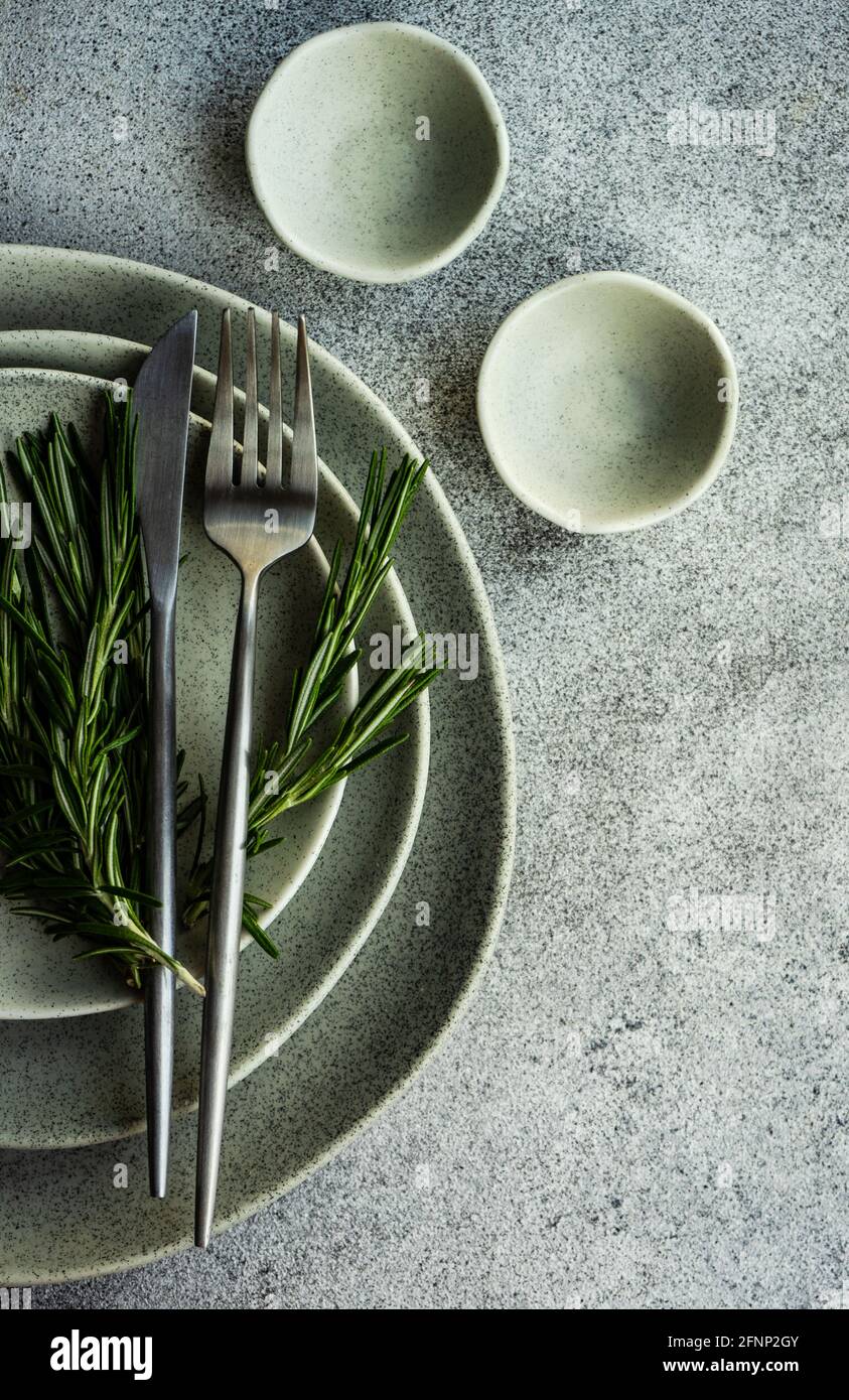 Minimalistic table setting with rosemary Stock Photo - Alamy