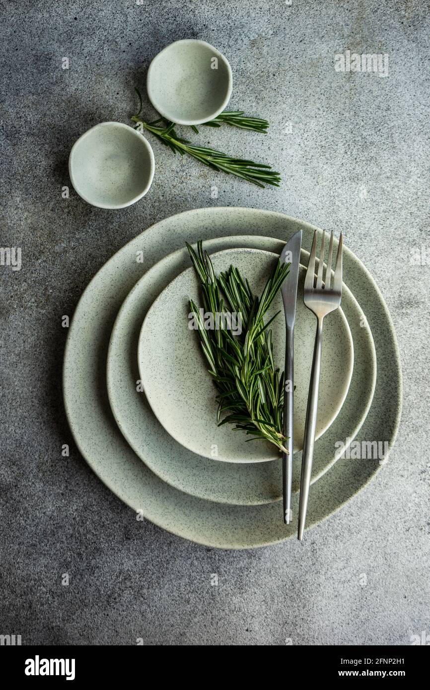 Minimalistic table setting with rosemary Stock Photo - Alamy