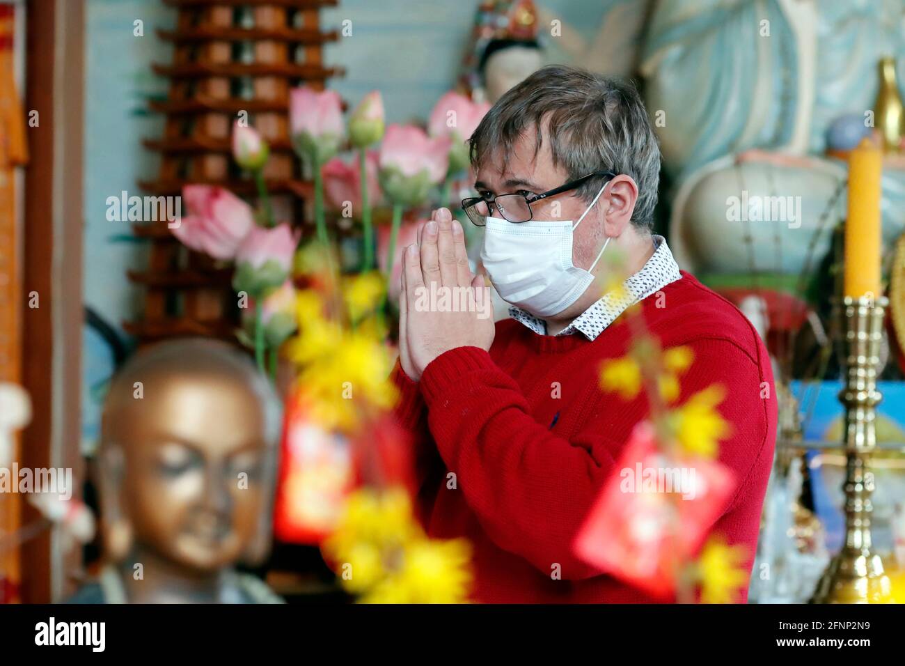 Man praying in buddhist temple. France Stock Photo - Alamy