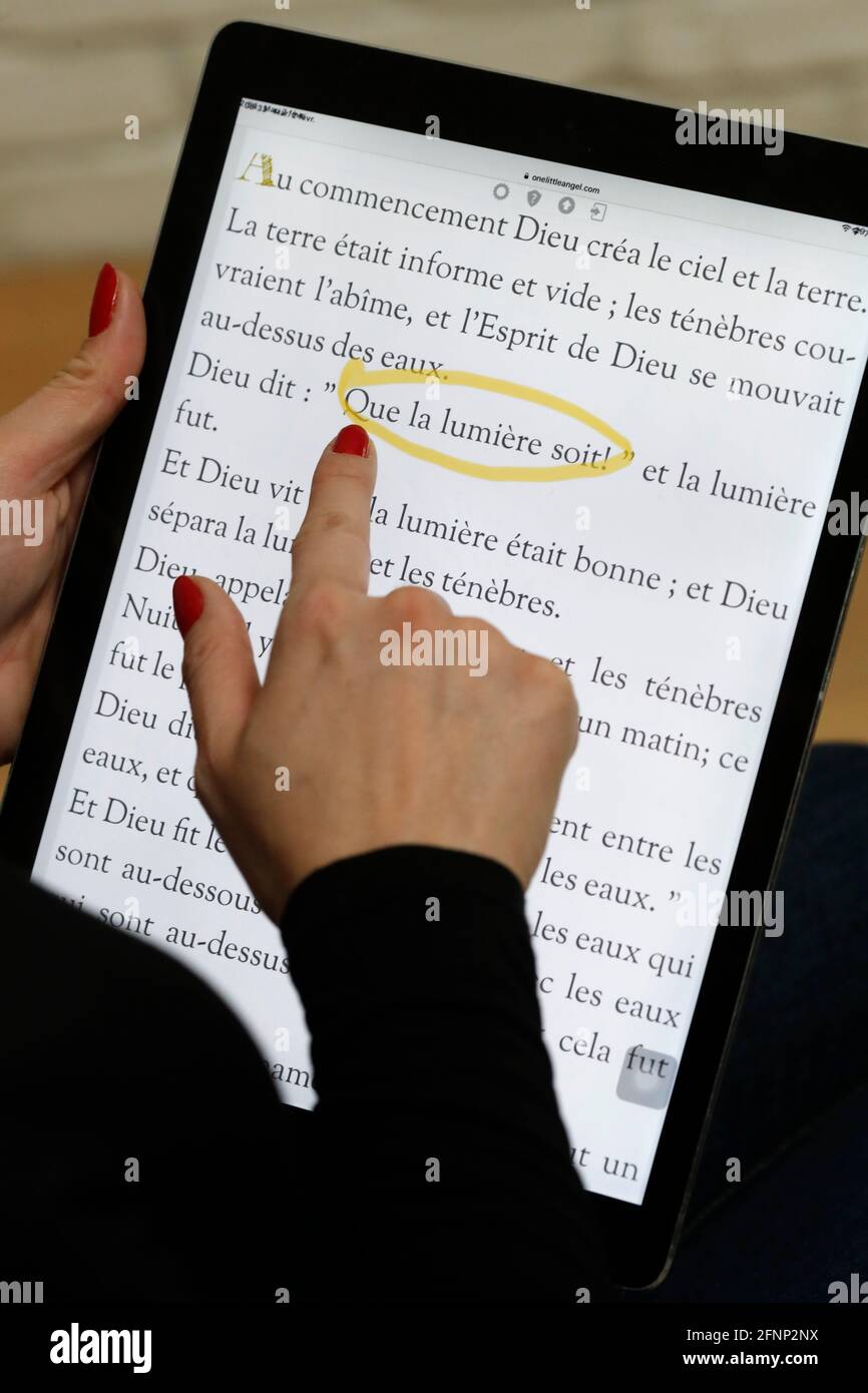 Woman reading and studying the gospels of the bible on a digital tablet ...