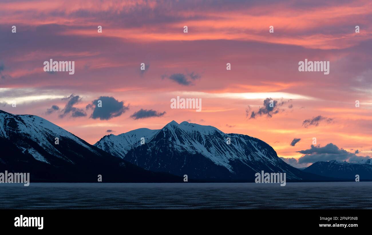 Stunning sunset over snow capped mountain peaks in northern Canada ...