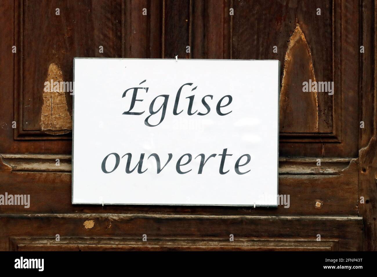 Church open sign on a door. Albens. France Stock Photo - Alamy