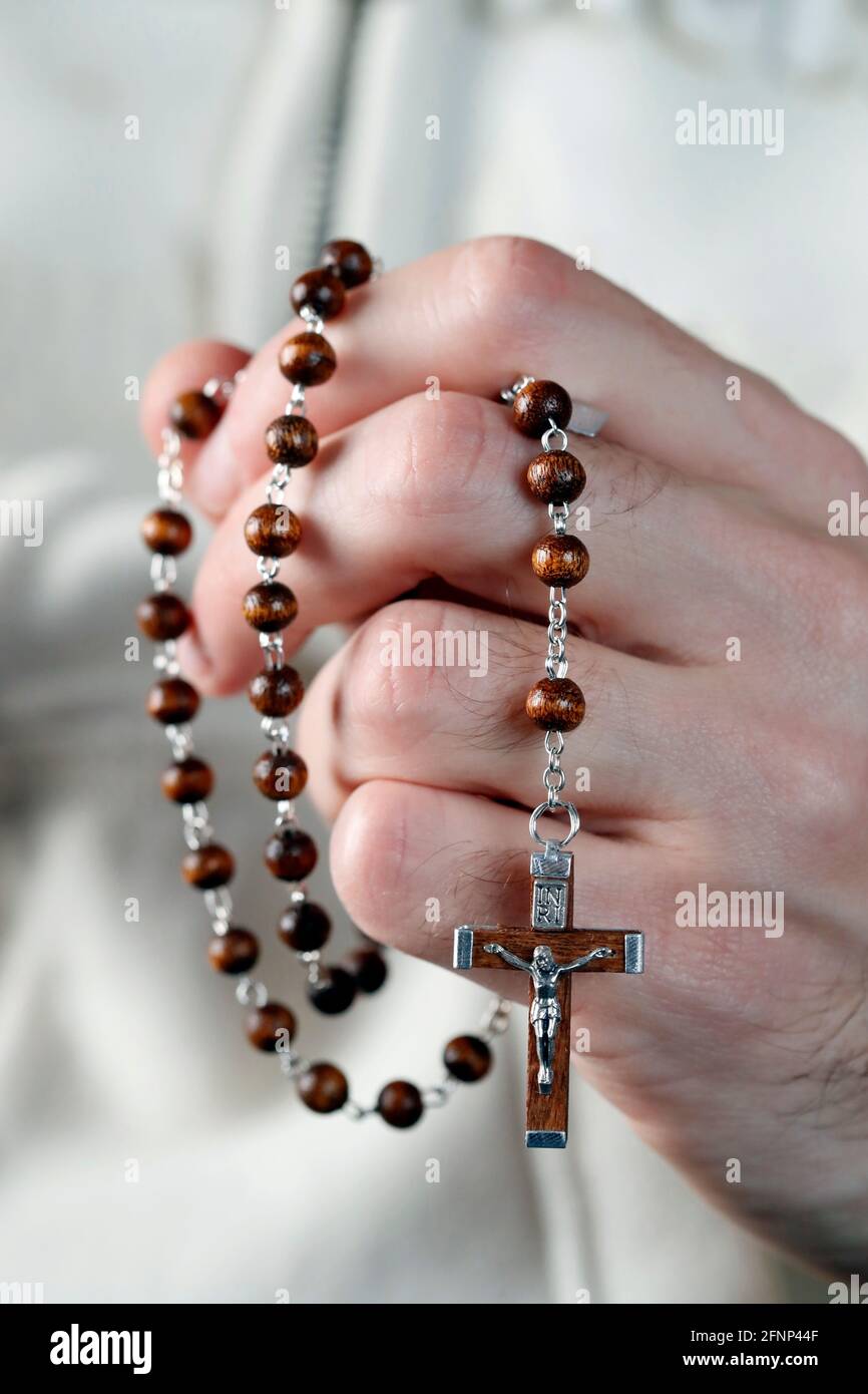 Catholic man praying with prayer beads. Close up on hands. France Stock ...