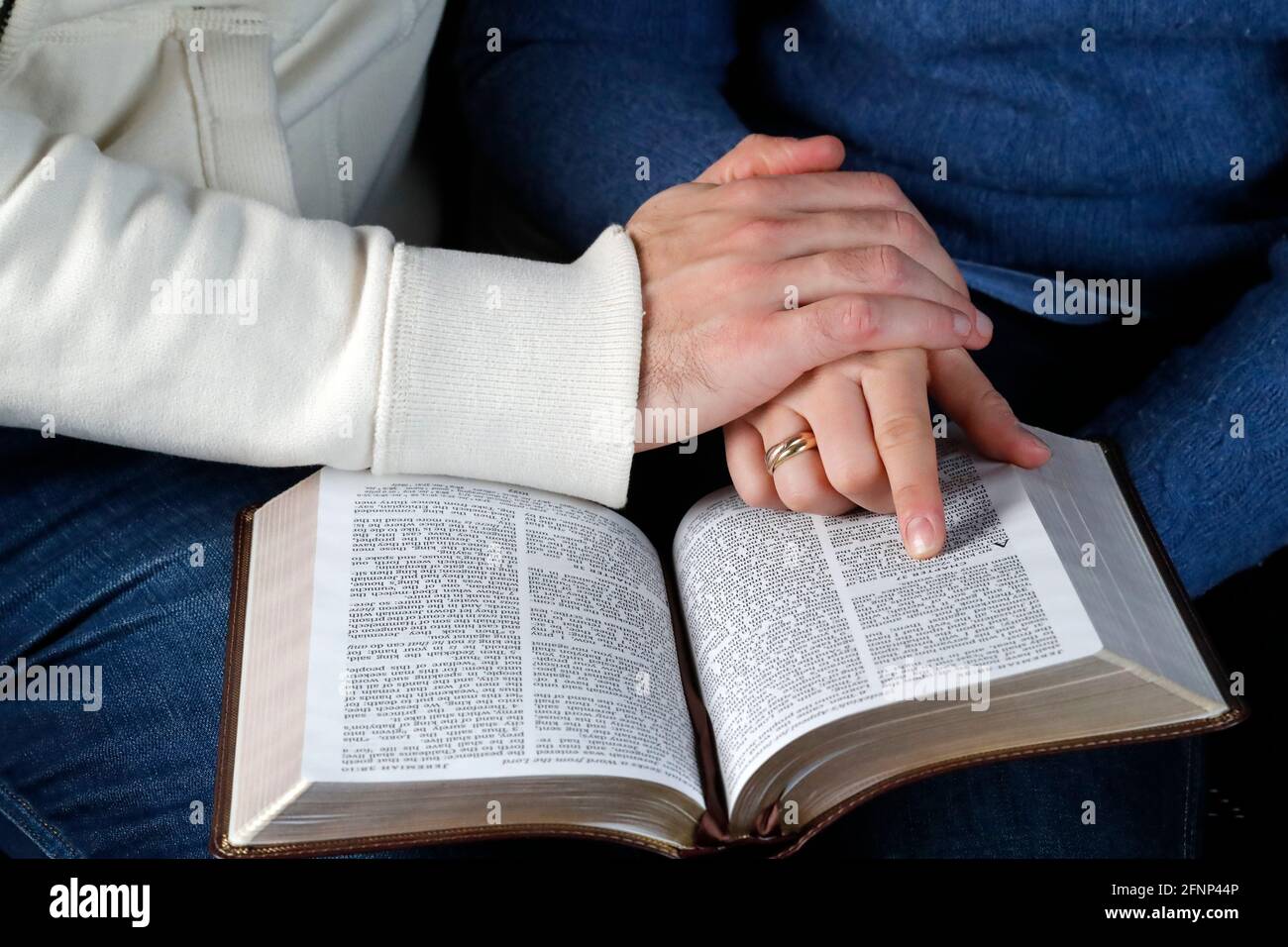 Man and woman reading together the bible at home. Christian couple ...