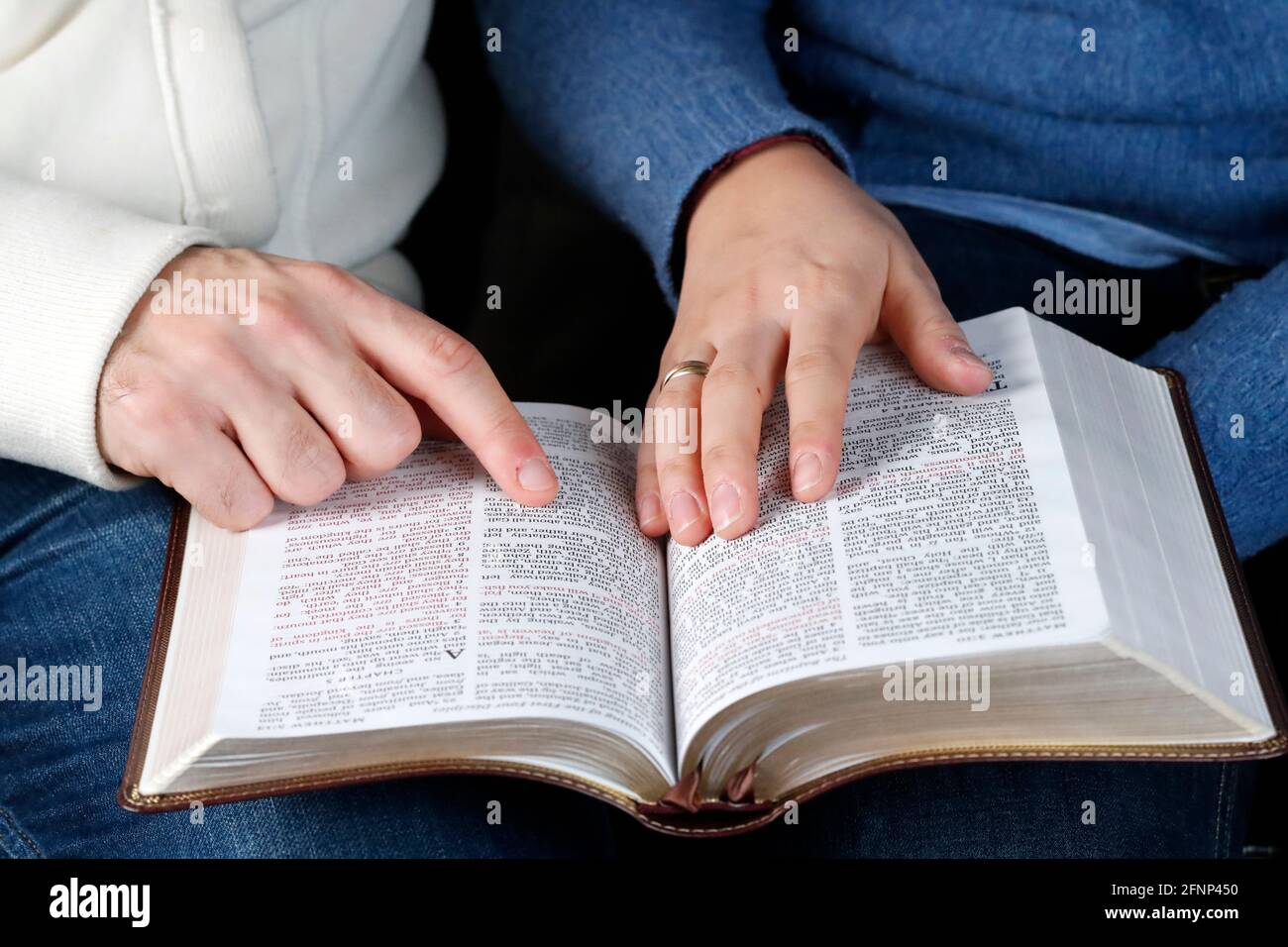 Man and woman reading together the bible at home. Christian couple ...