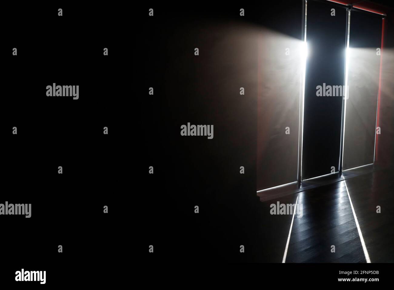Light through the gap of an open door. France Stock Photo - Alamy
