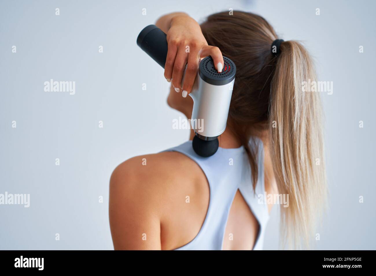 Woman getting anti-cellulite and anti-fat therapy over light background ...