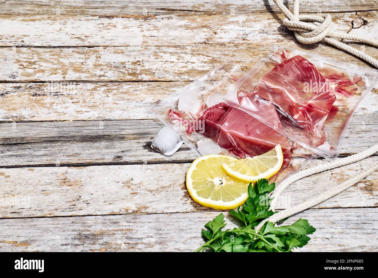 Red tuna fillets in vacuum package on gray wooden background. Fresh ...
