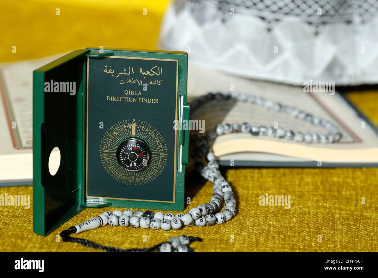 Quran, Kufi cap, Qibla compass and prayer beads ( misbaha ) . Symbols ...