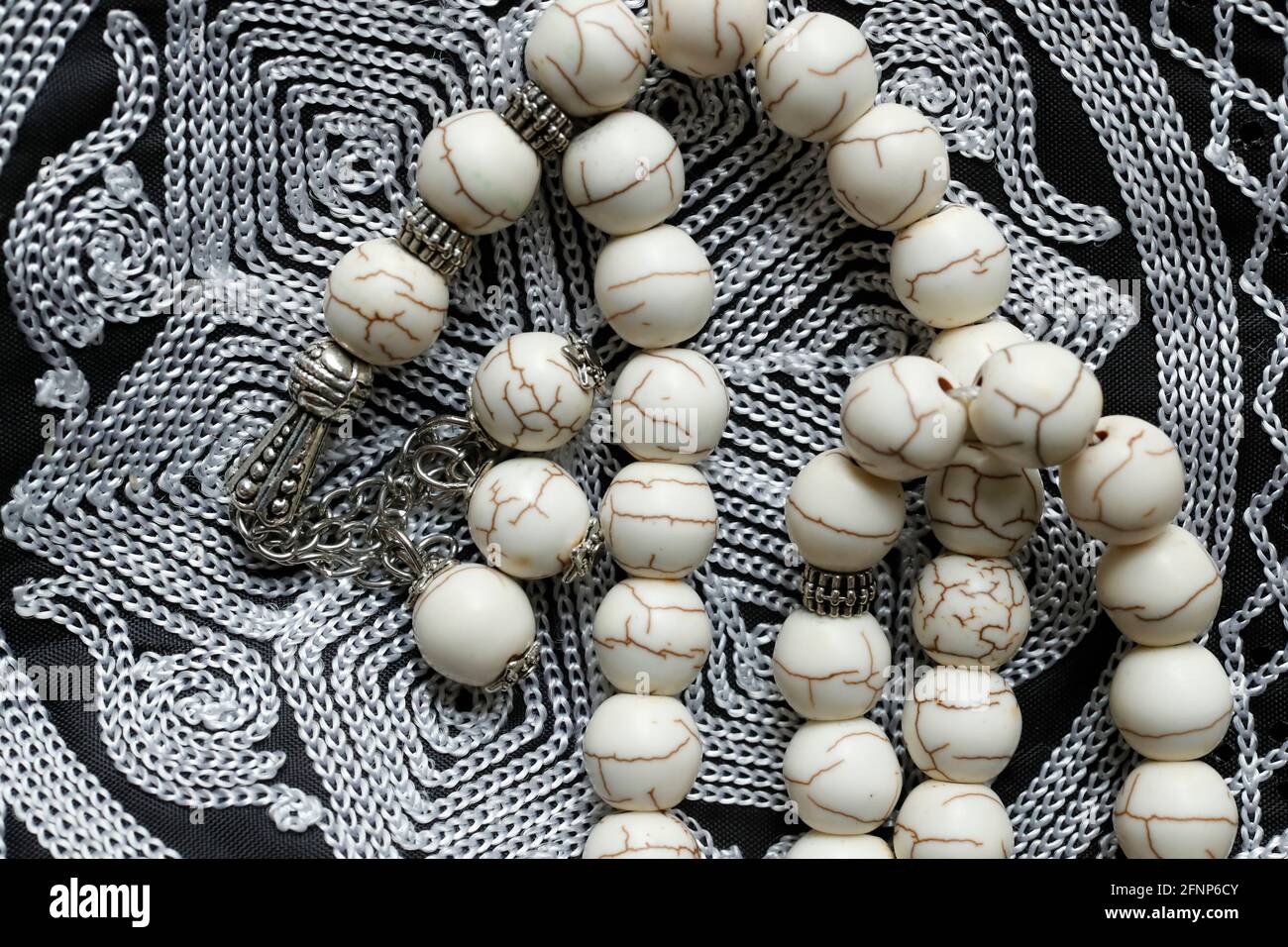 Kufi cap and prayer beads ( misbaha ) . Symbols of Islam. Dubai. United ...