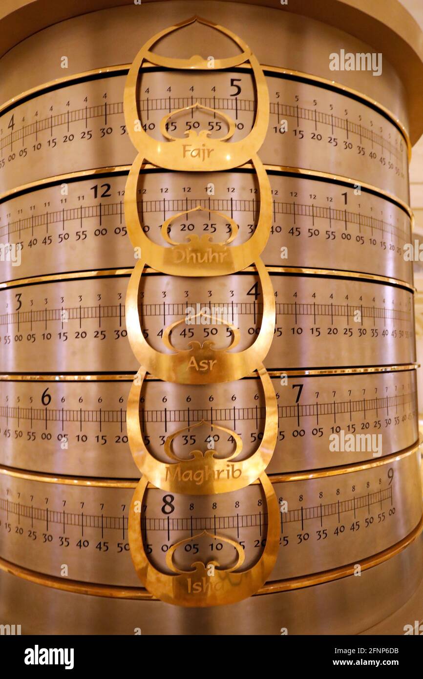 Display showing prayer times. The daily obligatory prayers observed ...