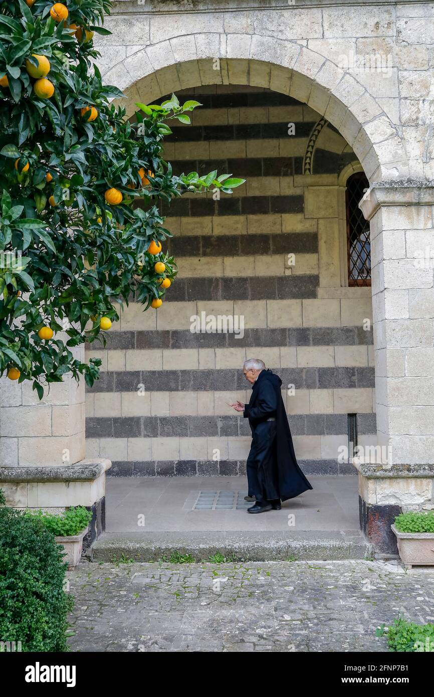 Lay man and benedictine monk in San Pietro di Sorres basilica cloister ...