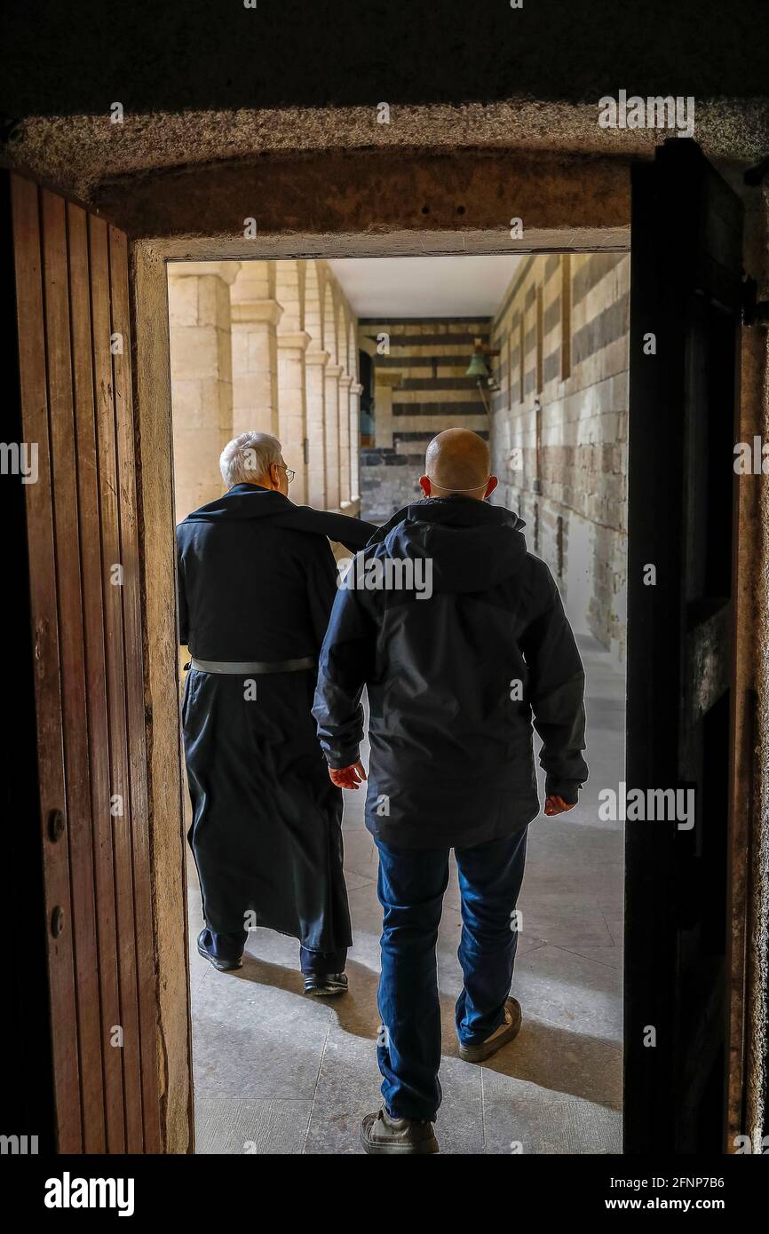 Lay man and benedictine monk in San Pietro di Sorres basilica cloister ...