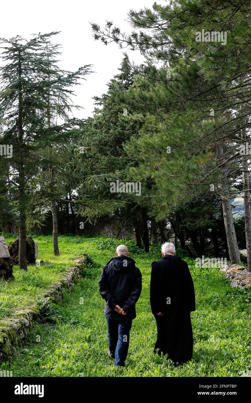 Lay man and benedictine monk in San Pietro di Sorres basilica garden ...