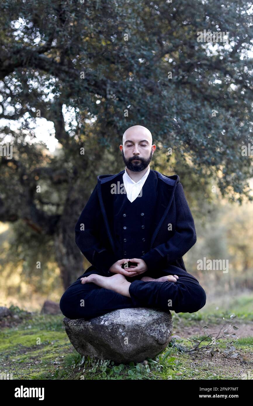 Sardinian man sitting and meditating in Biru 'E Concas megalitic ...