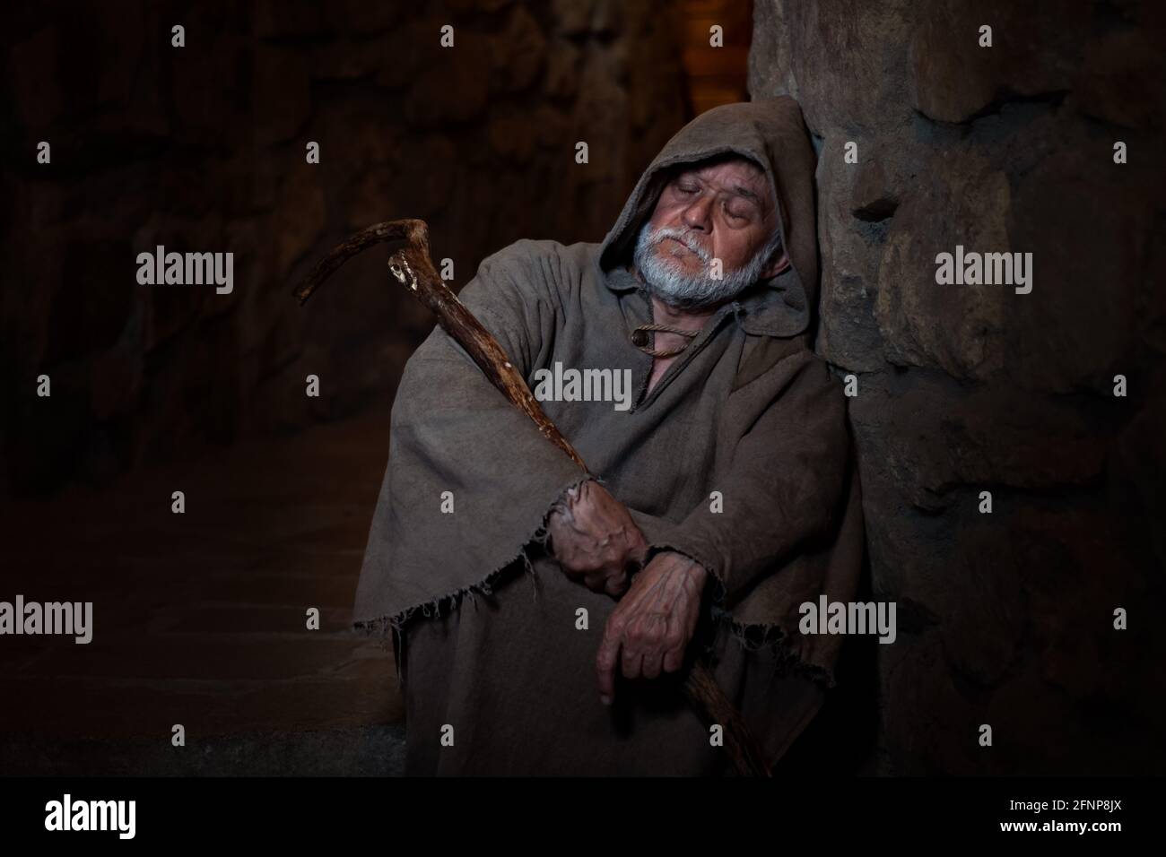 Old poor medieval beggar sleeps in alley Stock Photo - Alamy