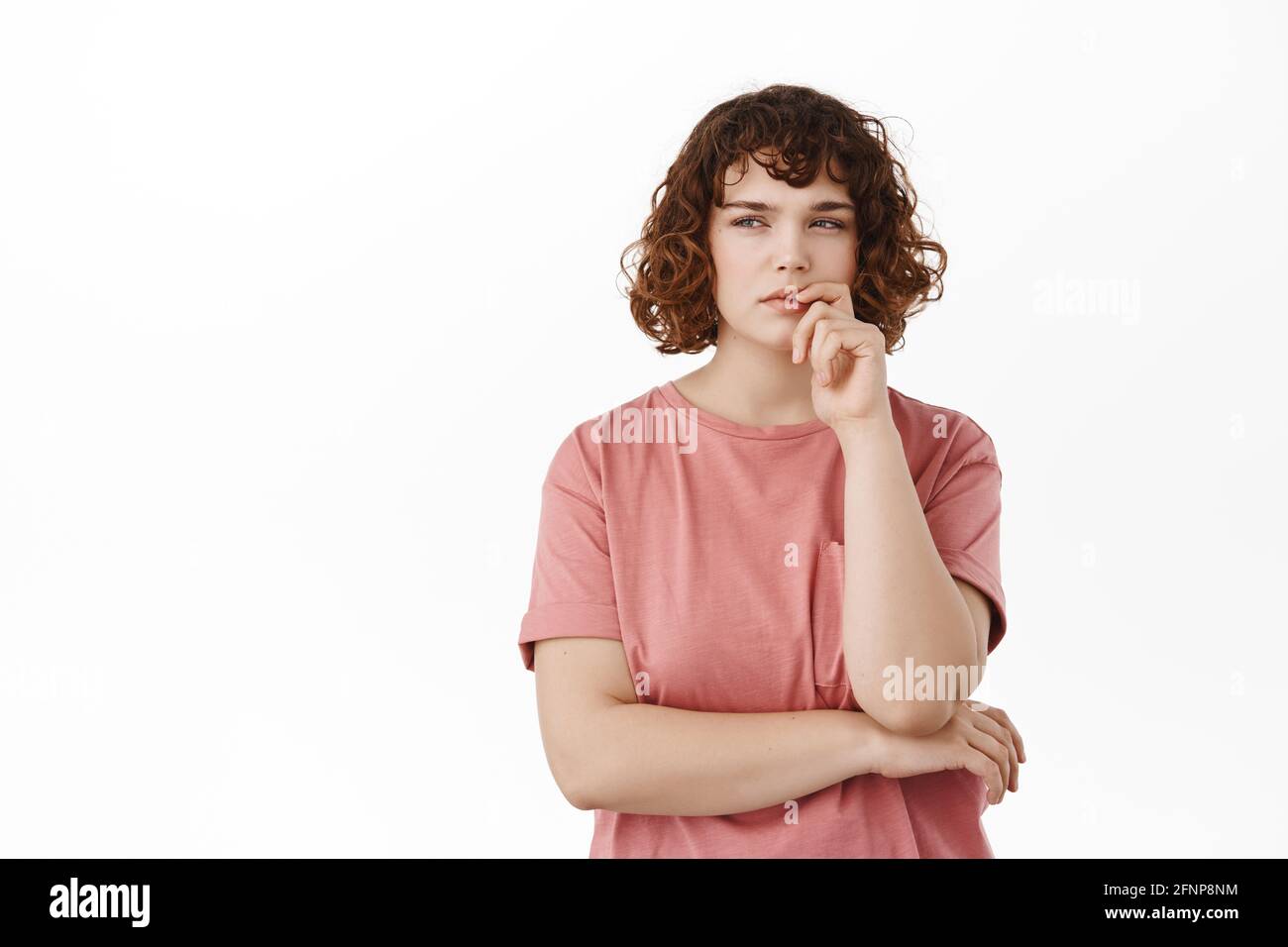Thoughtful curly girl, looking aside with pensive serious face ...