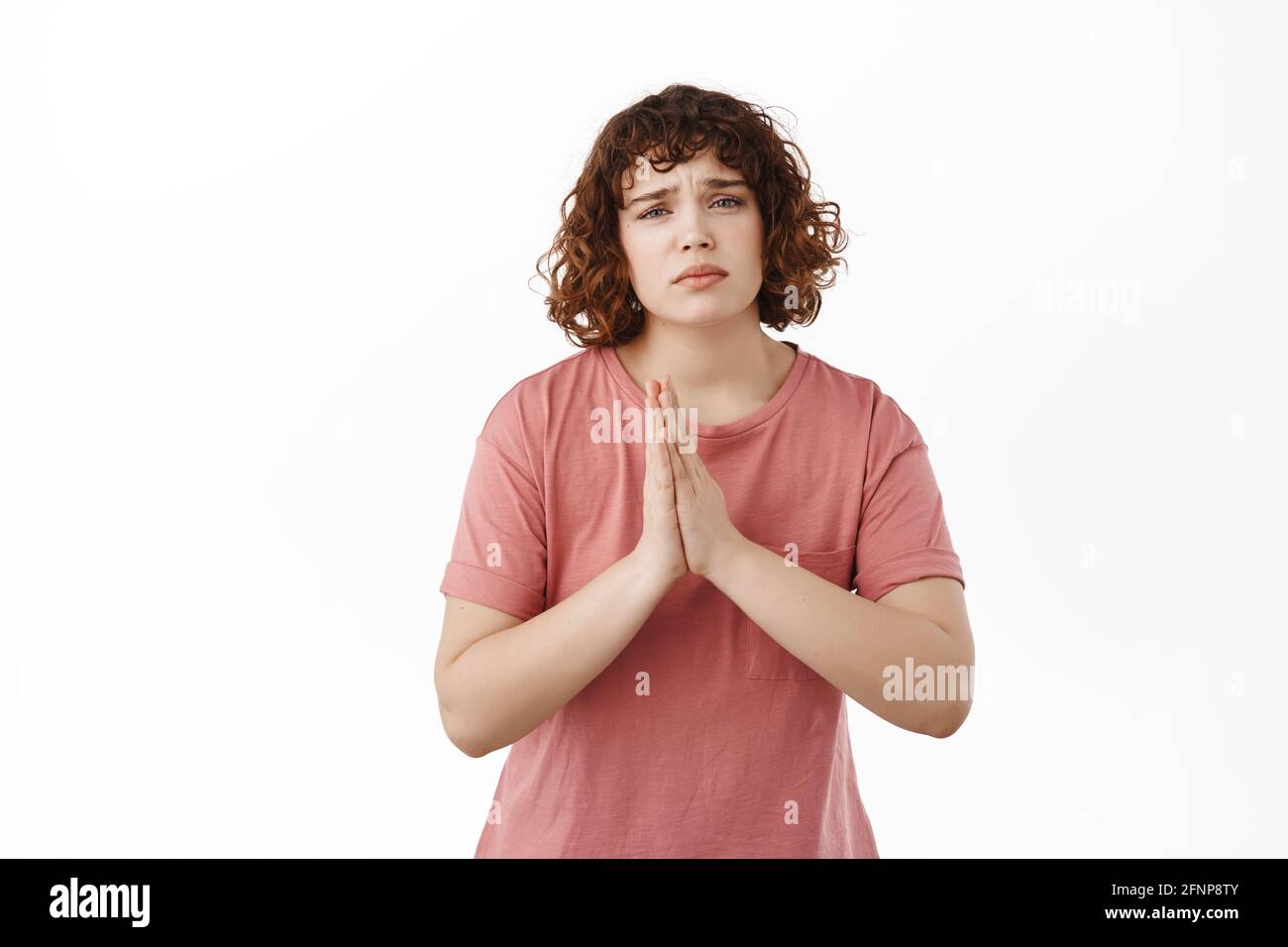 Please I beg you. Needy and coy young woman begging for help, pleading ...