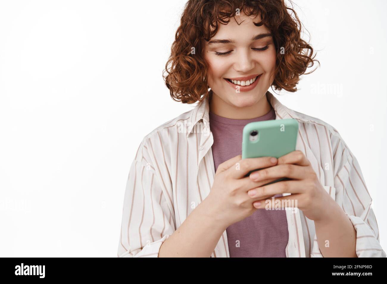 Modern candid girl chatting on phone, texting message or using mobile ...