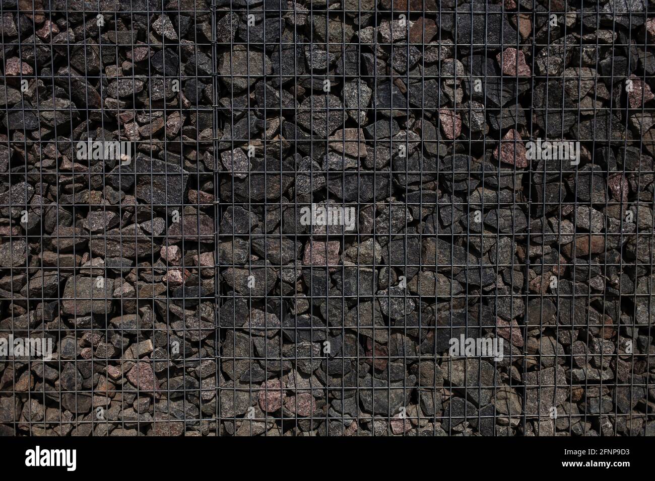 Stone wall with metal grid as background. Rock texture Stock Photo - Alamy