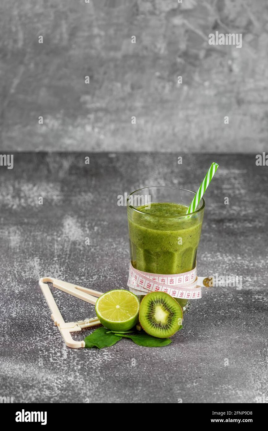 Fresh smoothie drink in a tall glass glass with centimeter wrapped ...