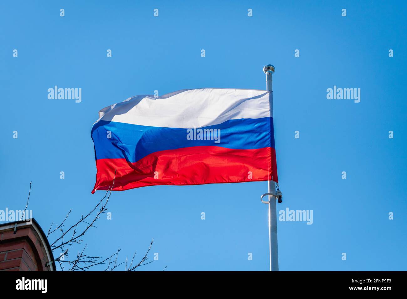 Russian flag against the blue sky. Flag of the Russian Federation Stock ...