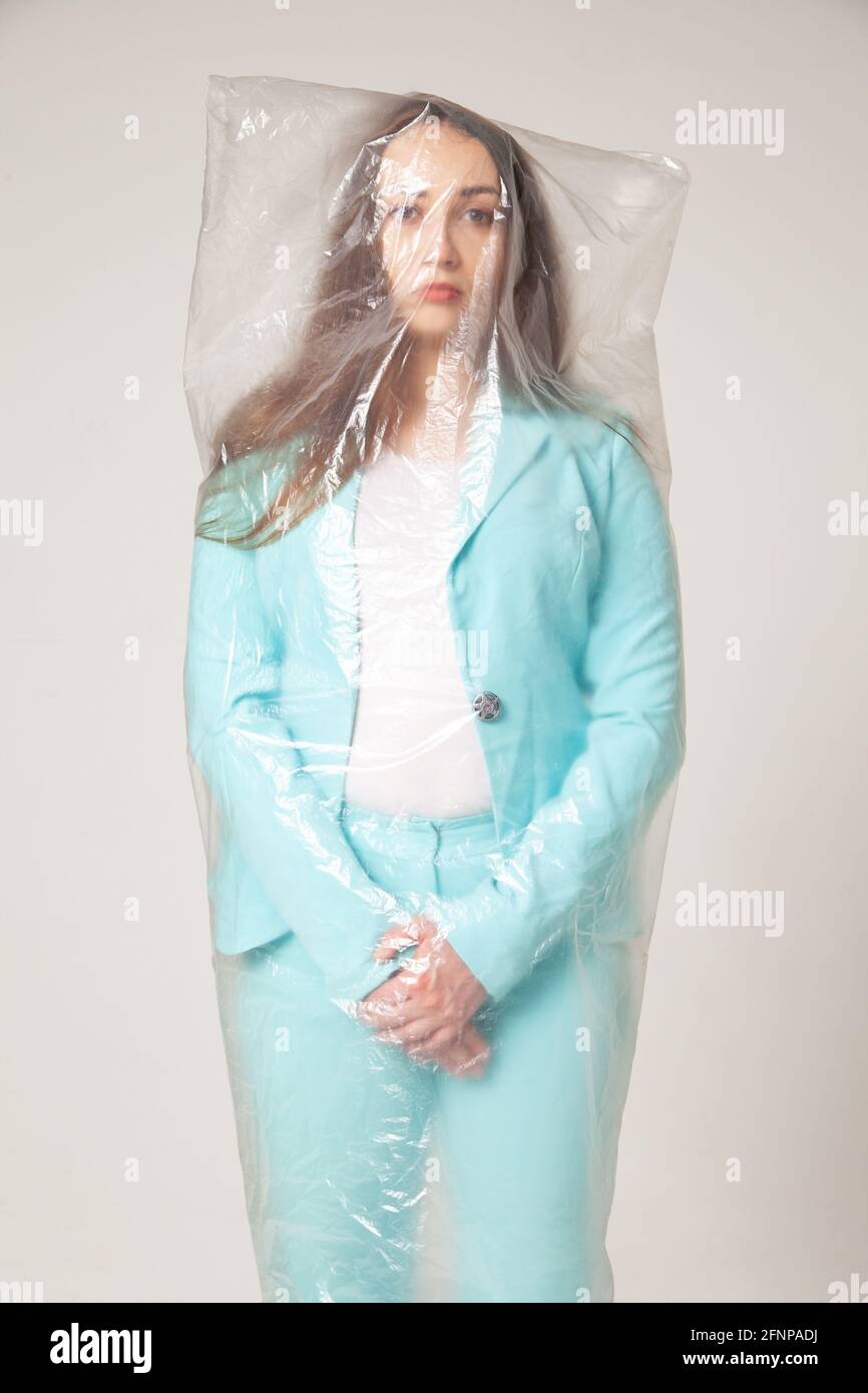 Full body trendy young female in blue suit covered with transparent ...