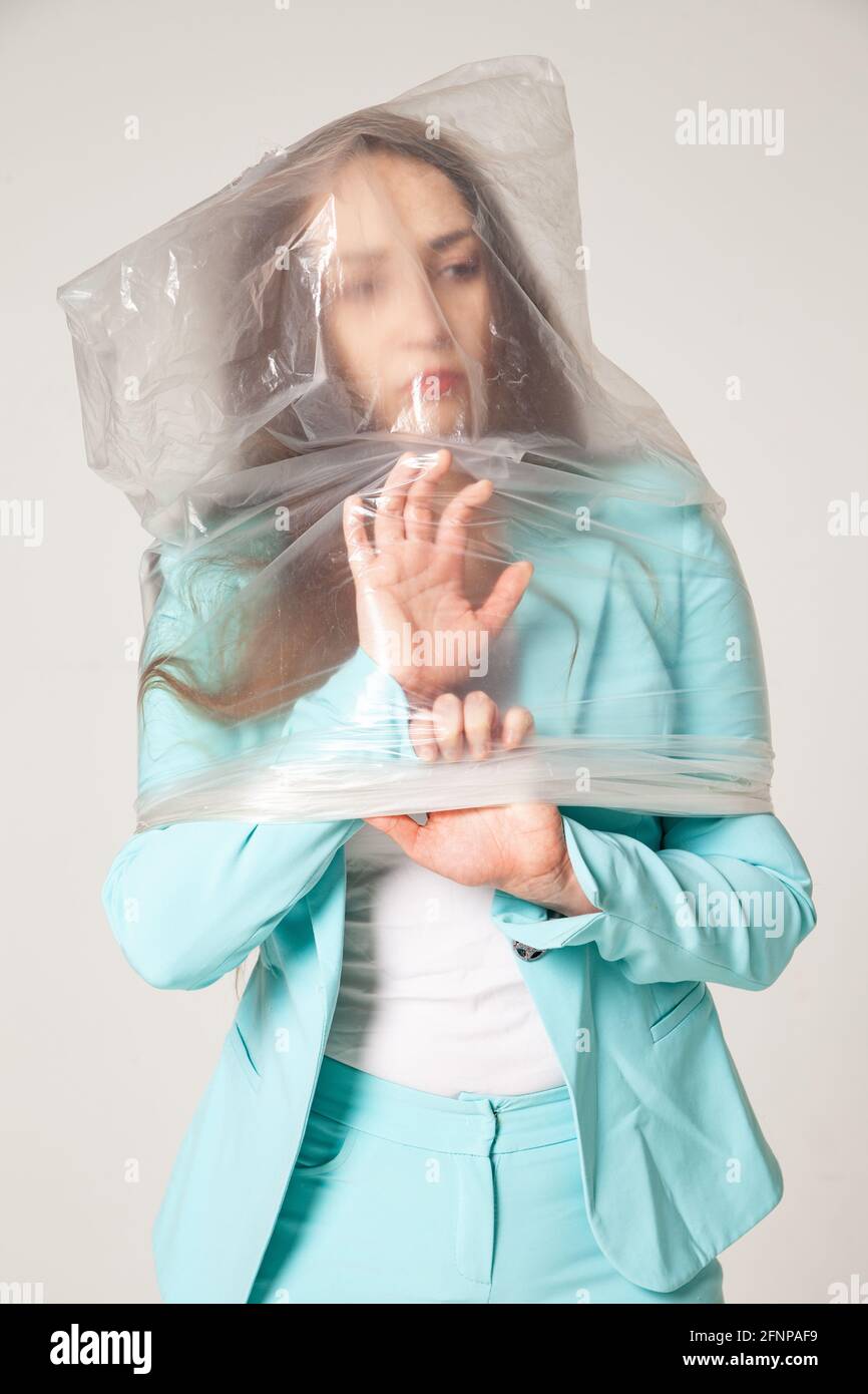 Full body trendy young female in blue suit covered with transparent ...