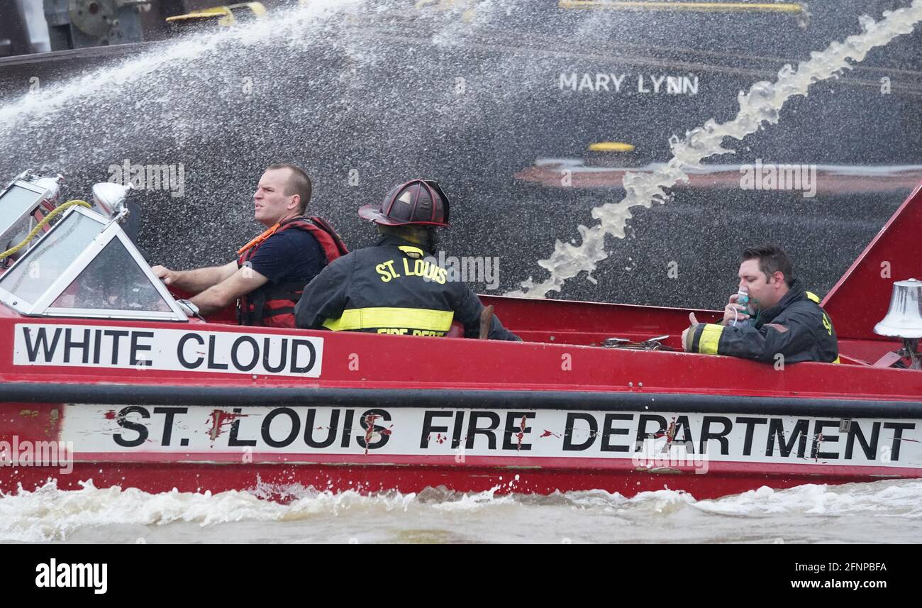 St. Louis, United States. 18th May, 2021. A St. Louis firefighter uses ...