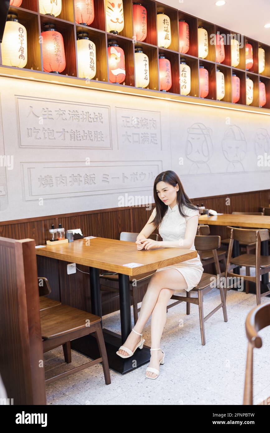 Beautiful young asian woman in traditional white dress named cheongsam ...