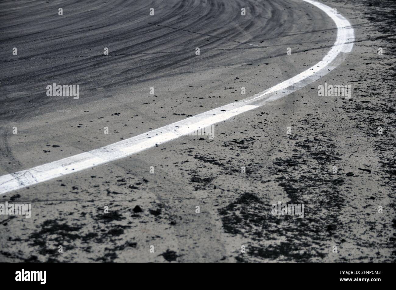 Racing curve. Remains of rubbed rubber on the asphalt of the race track ...