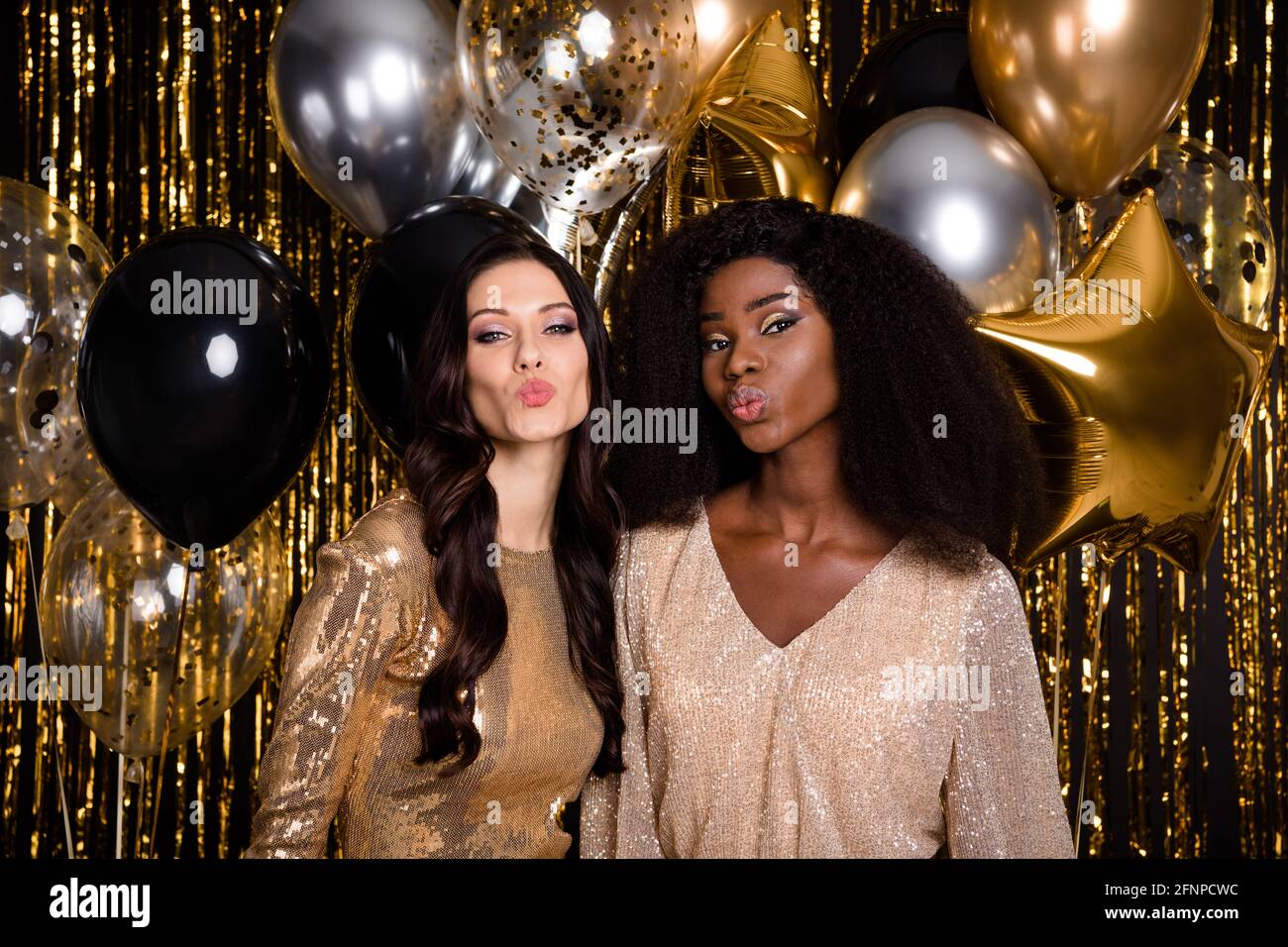 Photo of two coquette affectionate ladies send air kisses balloon ...